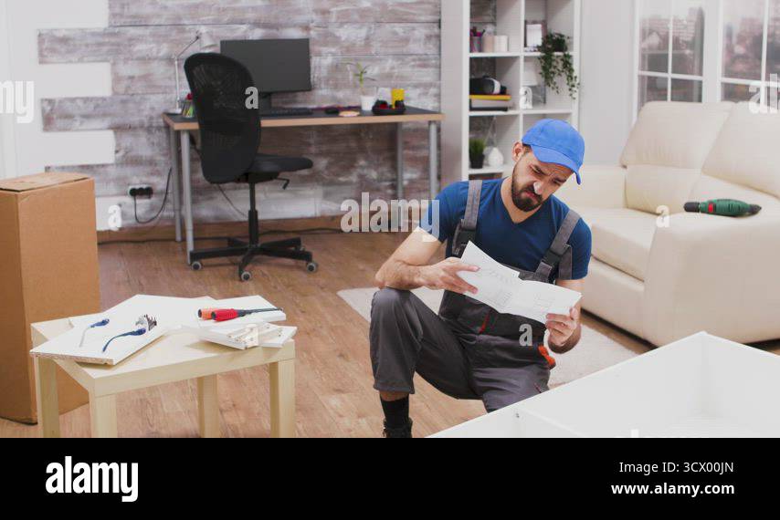 Confused male worker while assembling a shelf Stock Video Footage - Alamy