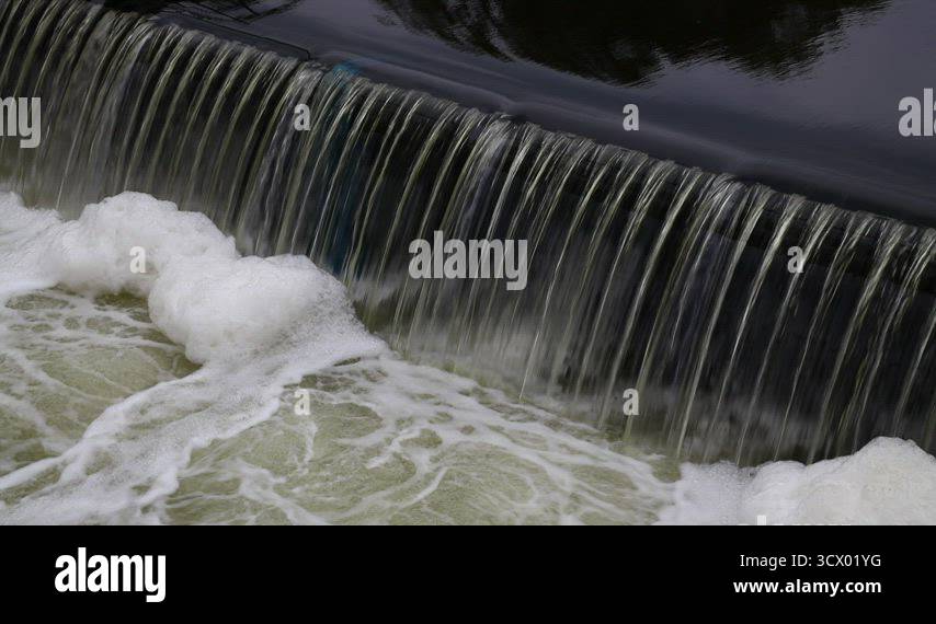 Dirty river water falling from rift and foam Stock Video Footage - Alamy