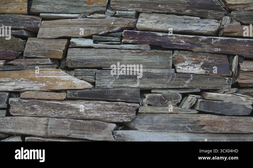 Stone wall made of multi-colored layered natural sandstone Stock Video ...