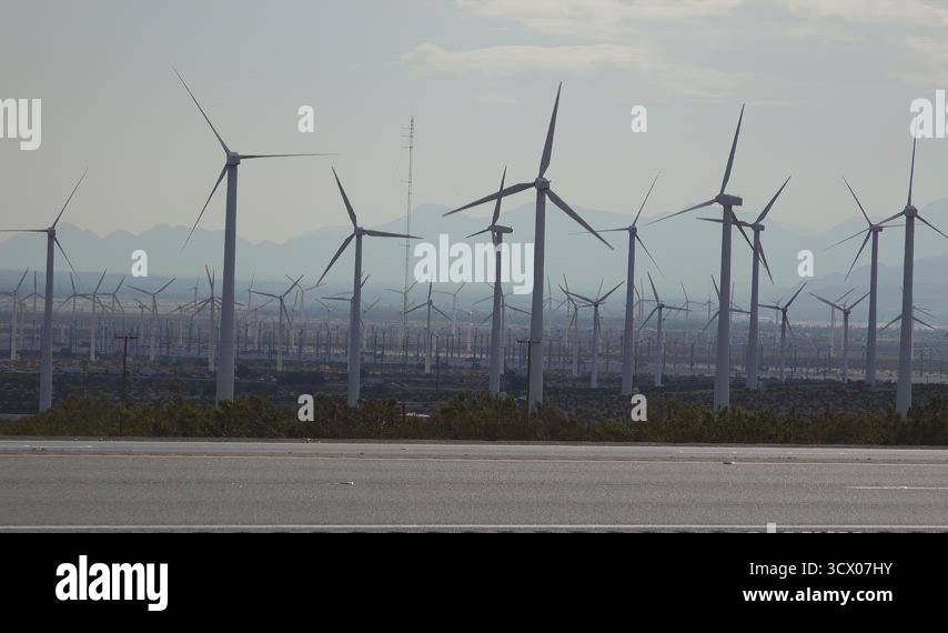 View of wind turbines generating electricity. Huge array of gigantic ...