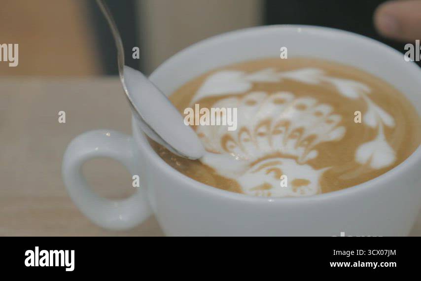 Close-up shot of barista finishing cream picture on latte matcha Stock ...