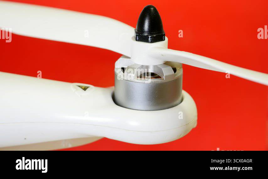 Brushless motor spinning with a white plastic propeller. Close up ...