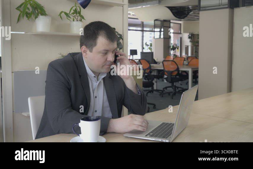 Boss in empty office works with modern device Stock Video Footage - Alamy