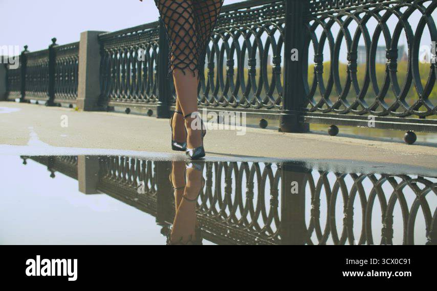 Female legs in high heels shoes walking in the puddle Stock Video ...