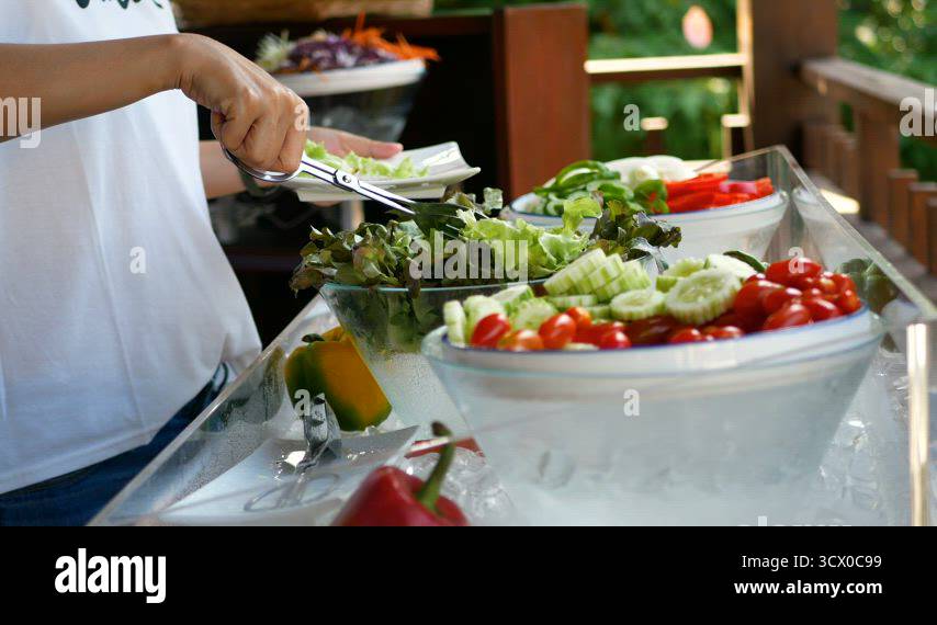 4K. woman select different organic vegetable on catering buffet food in ...