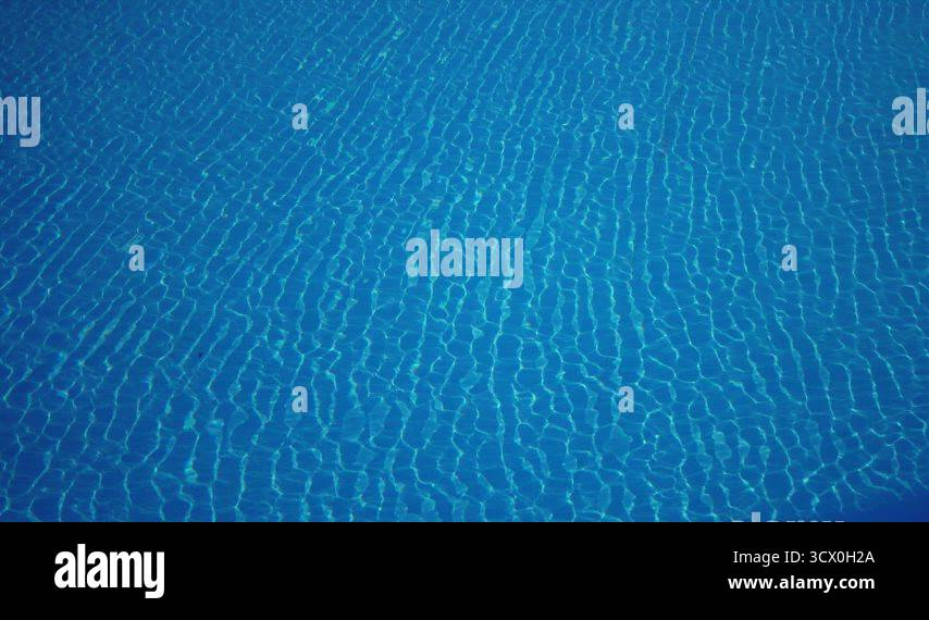 Water in the pool, sunlight is reflected, waves. Reflection and glare ...