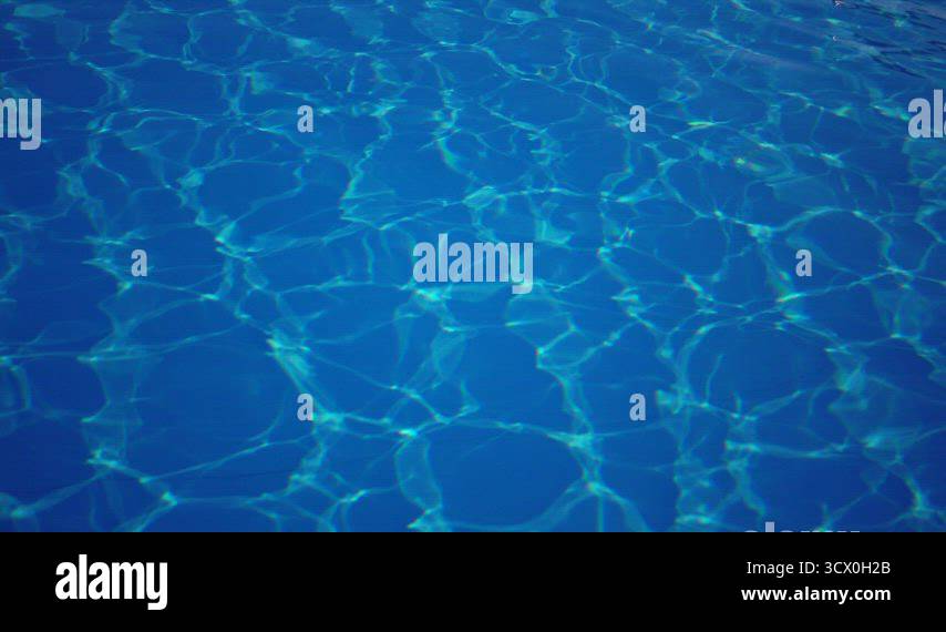 Water in the pool, sunlight is reflected, waves. Reflection and glare ...