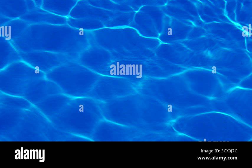 Water in the pool, sunlight is reflected, waves. Reflection and glare ...