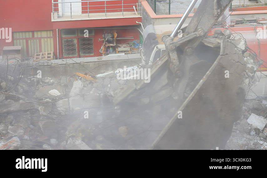 Heavy duty machinery running to get rid of the rubbish in a demolition ...