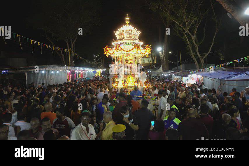 High angle front view silver chariot receive offerings from devotees ...