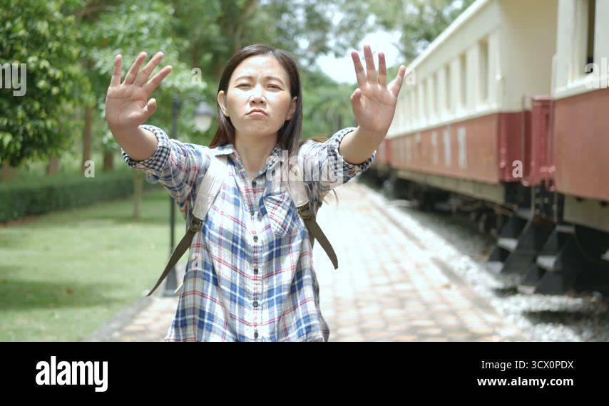 4K. Asian tourist woman waving hands to say goodbye in departe leaving ...