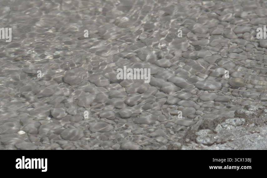 Hot water boils in the mouth of the operating geyser. Calcium ...