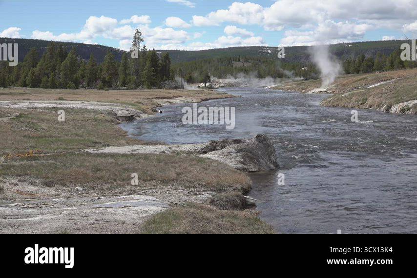 Valley with geysers along the river at Yellowstone National Park ...