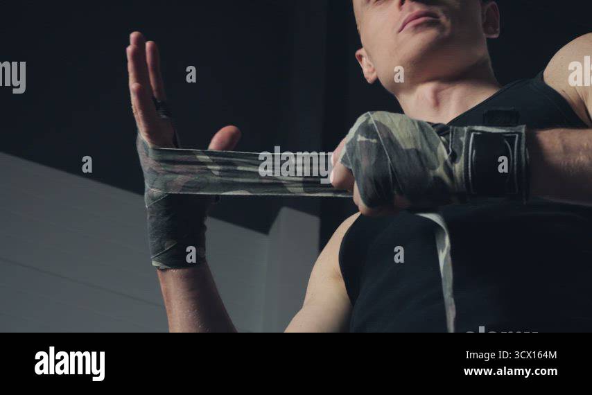 Low angle view of boxer wrapping bandage on hand Stock Video Footage ...