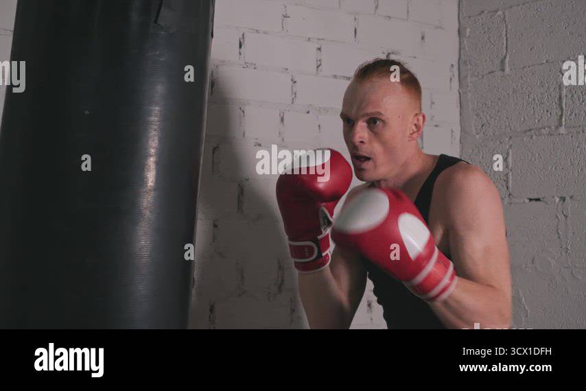 Boxer man training thai box blows on punching bag. Professional fighter ...
