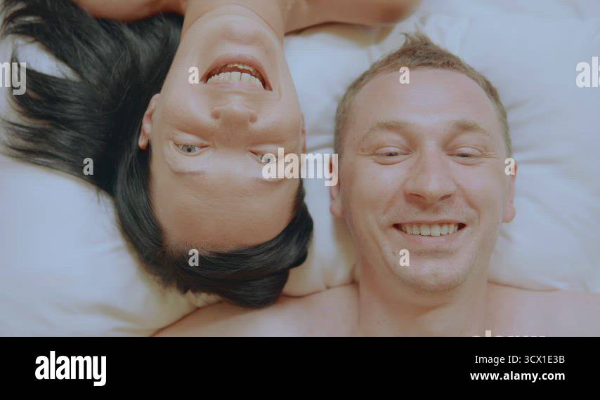 close up smiling faces pair on the bed Stock Video Footage - Alamy