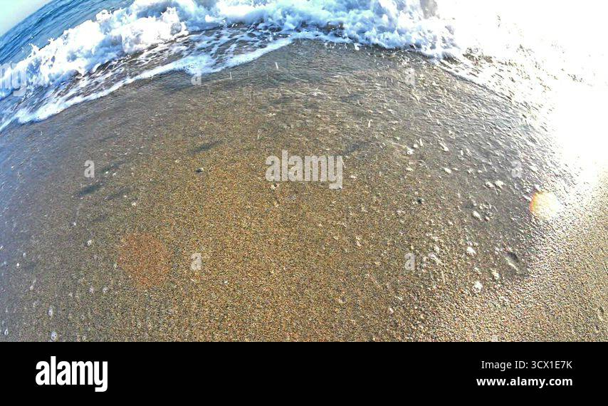 beach wave macro slow motion Stock Video Footage - Alamy