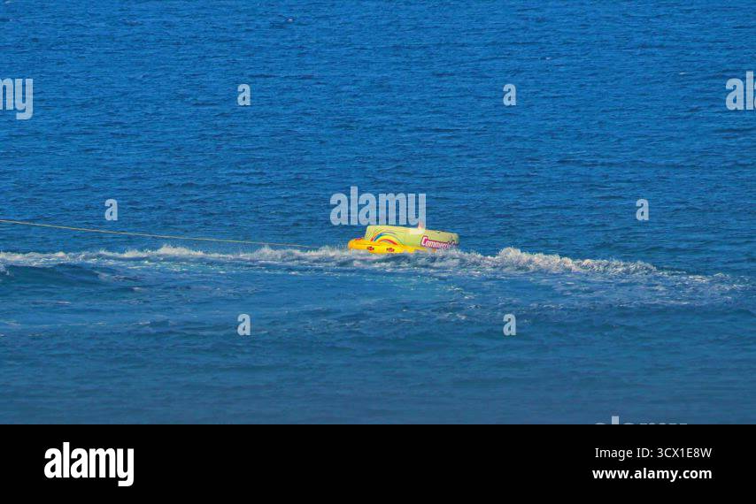 Happy tourists having fun riding inflatable boat at the blue sea 4k ...