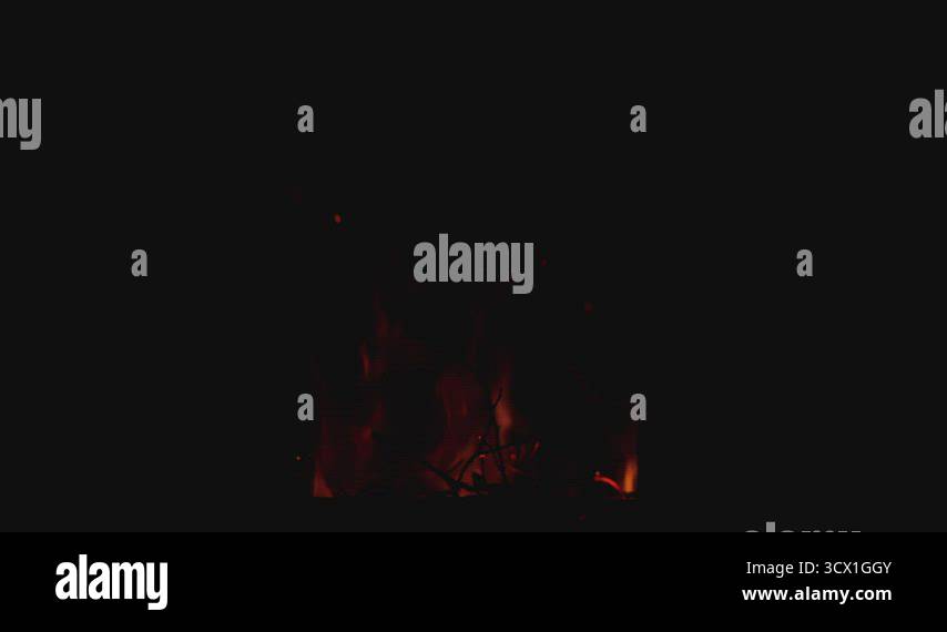 Real fire flames and sparks isolated on black background in slow motion ...