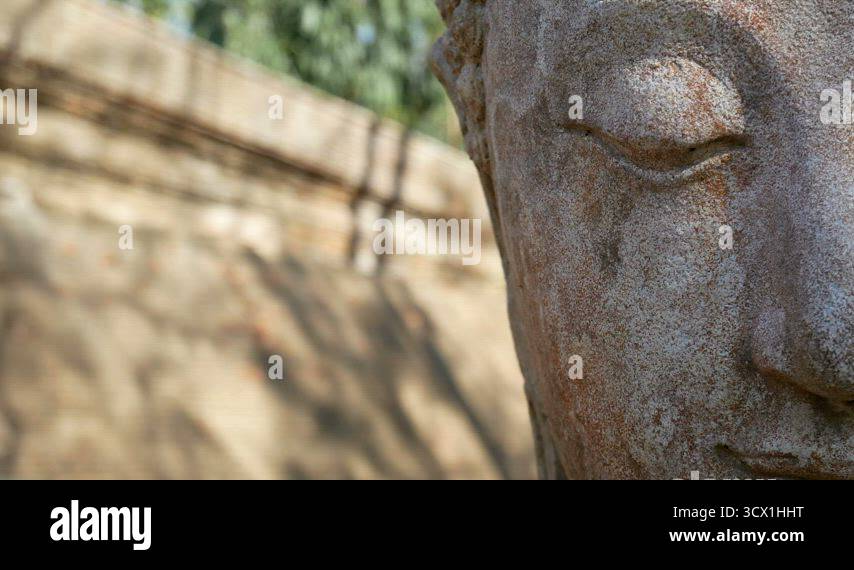 footage. Calm and peaceful face of old worship buddha statue head ...