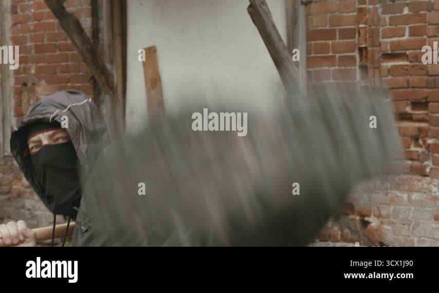 Angry hooligan in black mask and hood making kick to camera Stock Video ...