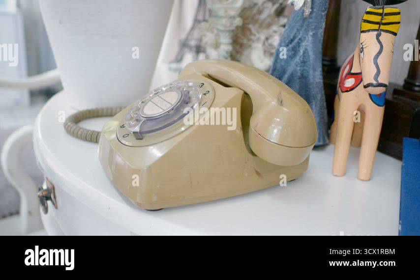 woman hand pick up old rotary style telephone on the table with vintage ...