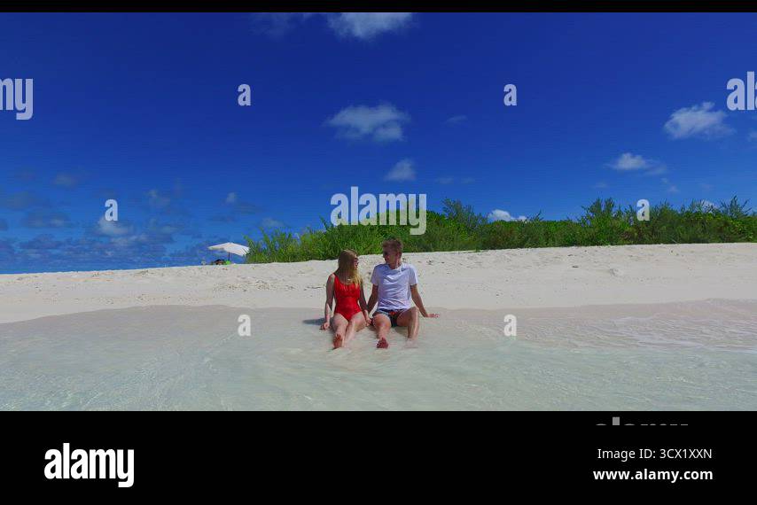 Fun man and woman on romantic honeymoon enjoy luxury on beach on summer ...