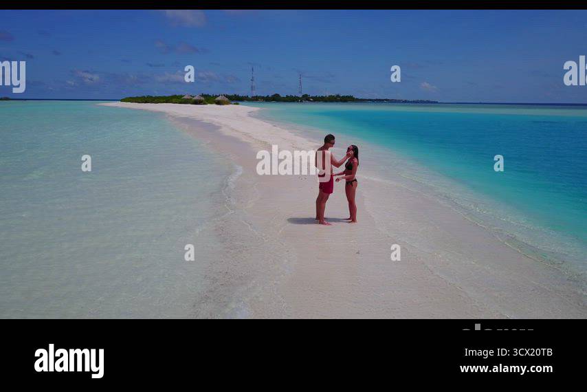Happy man and woman on honeymoon vacation have fun on beach on clean ...