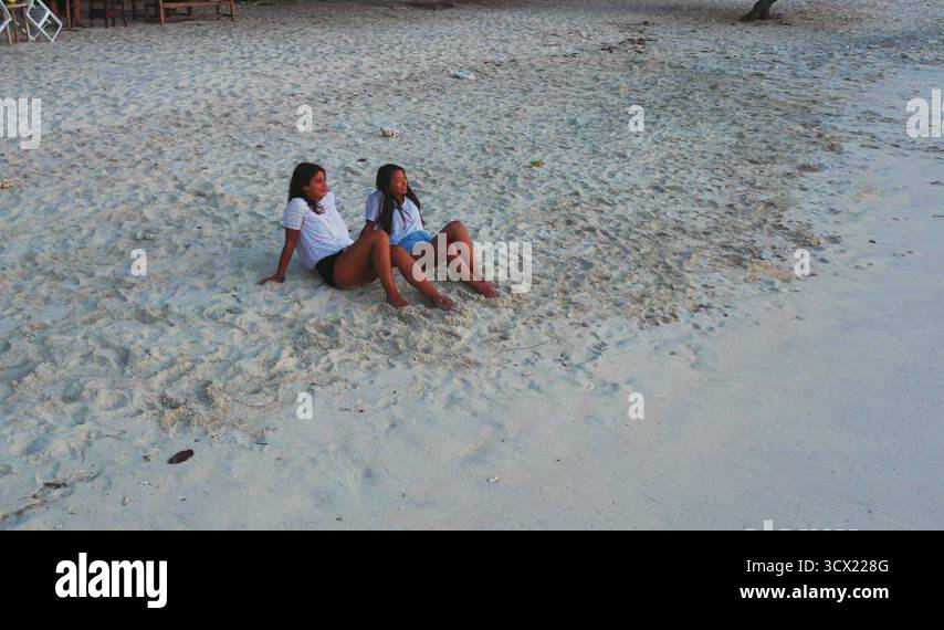 Modern happy ladies on vacation by the sea on beach on summer white ...