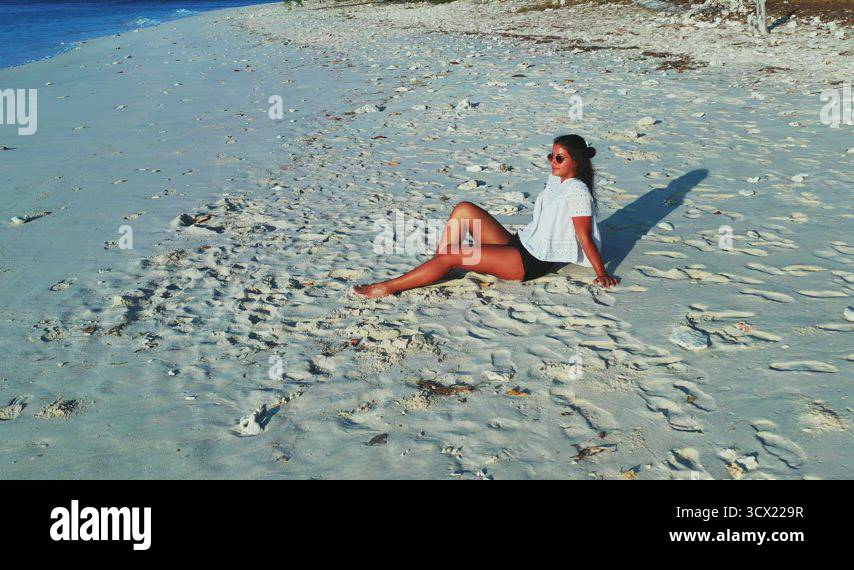 Young smiling girls on holiday in the sun at the beach on summer white ...