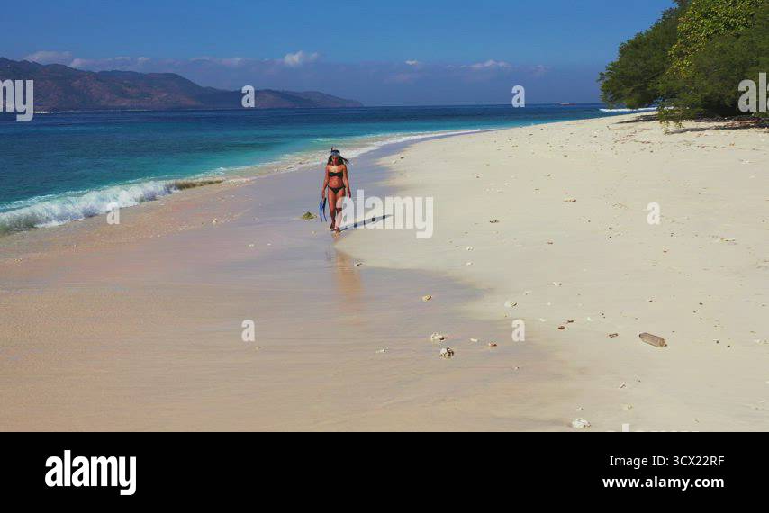 Modern smiling girls on holiday in the sun at the beach on paradise ...