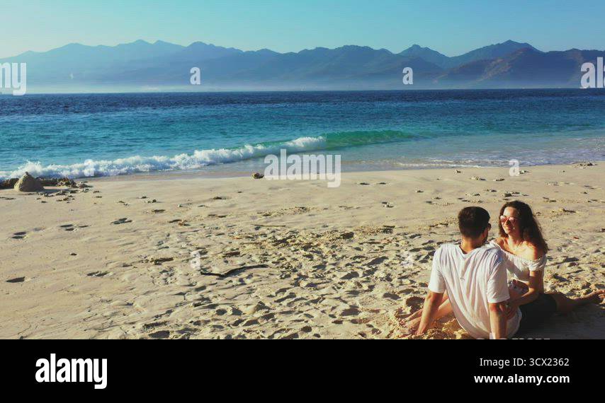 Young couple on honeymoon vacation spend quality time on beach on clean ...