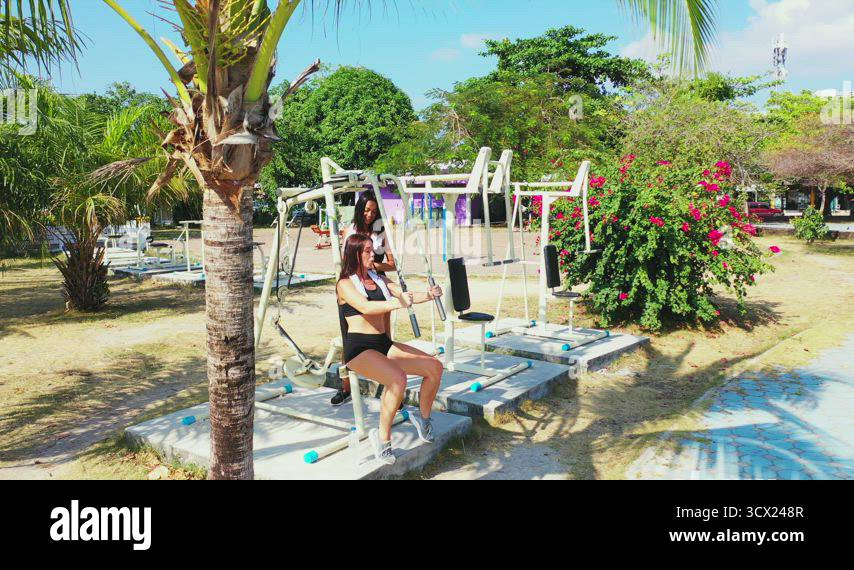 Young smiling girls on holiday in the sun on beach on summer white ...