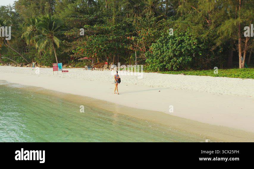 Young smiling girls on holiday in the sun on beach on summer white ...