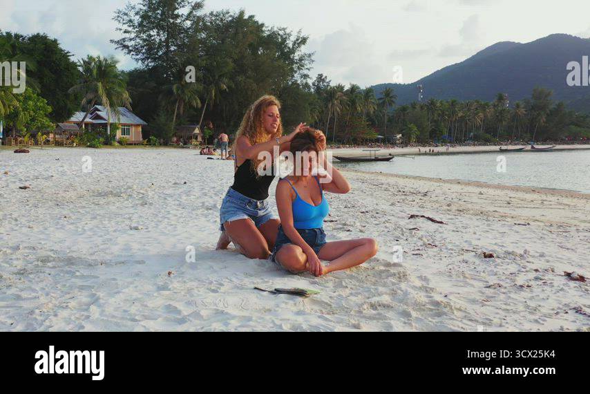 Pretty fun women on holiday in the sun on beach on sunny blue and white ...