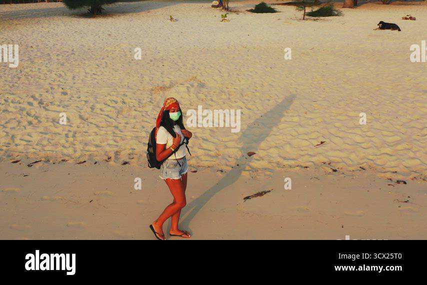 Pretty fun women on holiday in the sun on beach on sunny blue and white ...