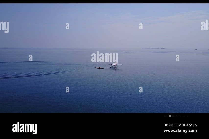 Wide angle overhead travel shot of a white sandy paradise beach and ...