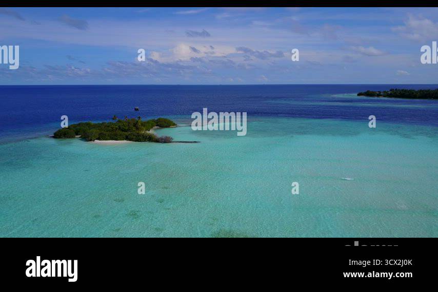 Daytime flying copy space shot of a white paradise beach and blue water ...