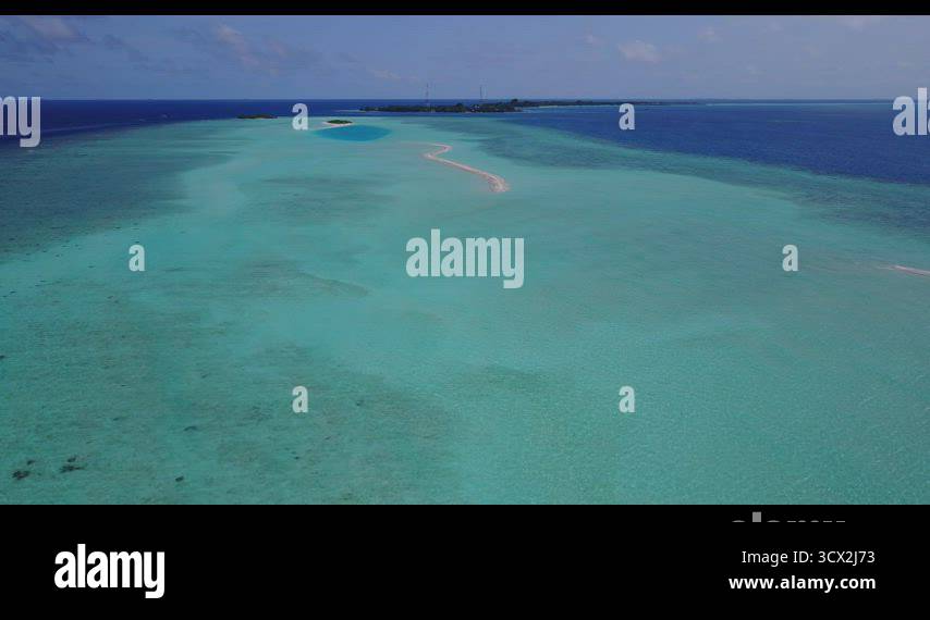 Wide overhead island view of a white sandy paradise beach and aqua blue ...