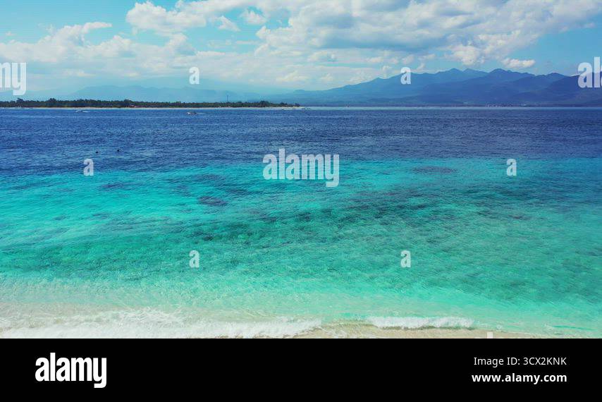 Daytime drone travel shot of a sandy white paradise beach and aqua blue ...