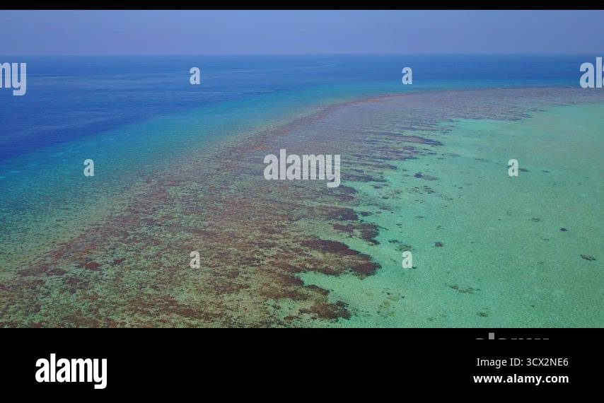 Natural aerial clean view of a sandy white paradise beach and blue ...