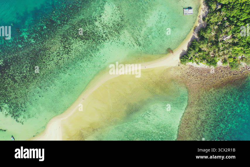 Wide angle overhead island view of a sandy white paradise beach and ...