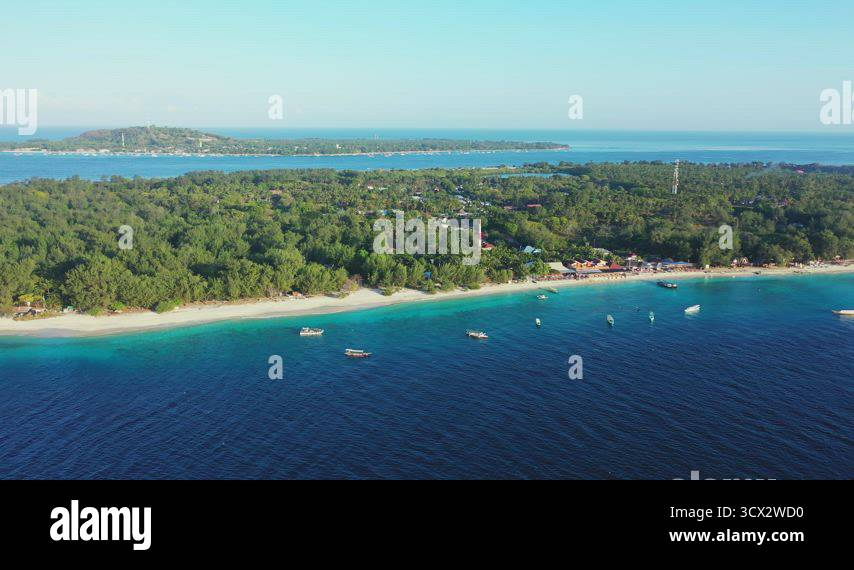 Wide drone island view of a sandy white paradise beach and blue sea ...