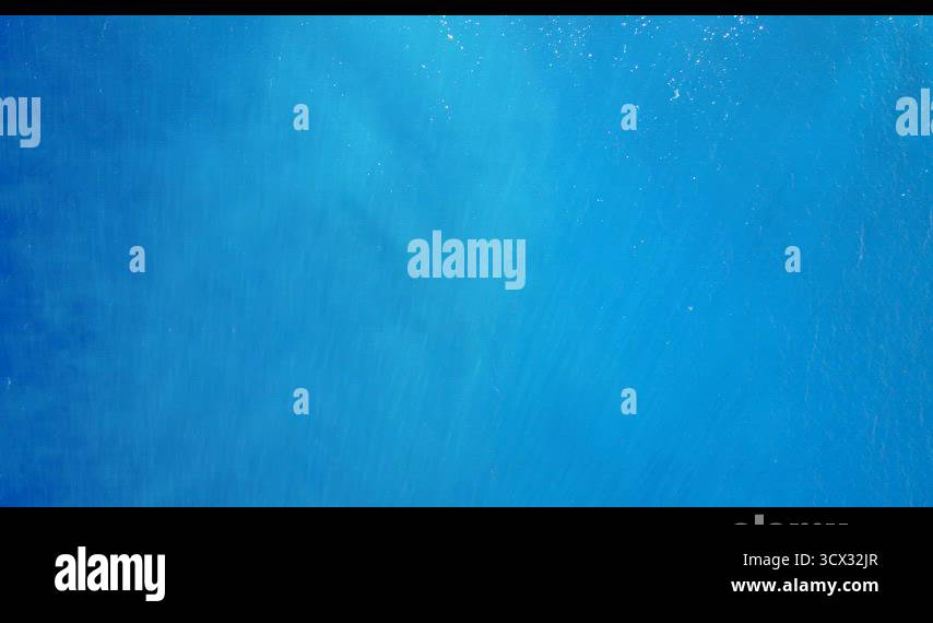 Wide overhead copy space shot of a sandy white paradise beach and blue ...