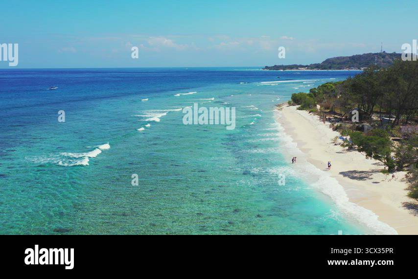 Daytime overhead clean view of a white sandy paradise beach and blue ...