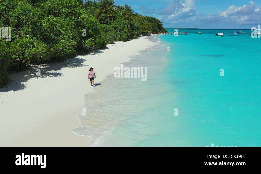 Pretty smiling girl on photoshoot spending quality time at the beach on ...