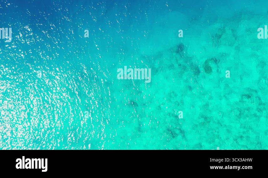 Wide overhead island view of a white paradise beach and aqua blue water ...