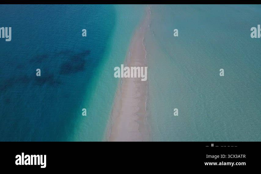 Wide angle overhead island view of a sandy white paradise beach and ...