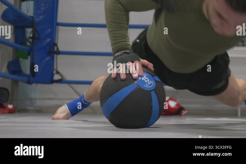 Fitness man training push up exercise with med ball in gym. Close up ...