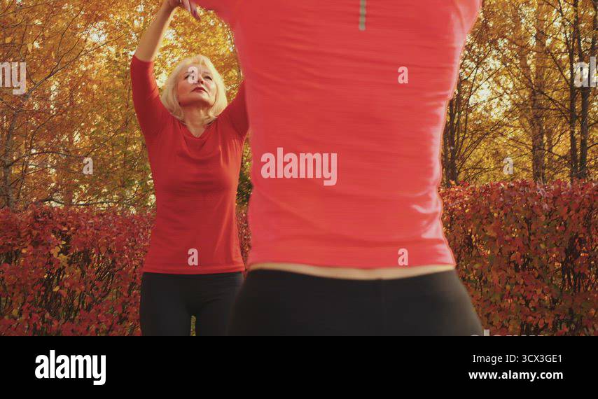 Fitness woman training stretching exercise in autumn park on sunshine ...